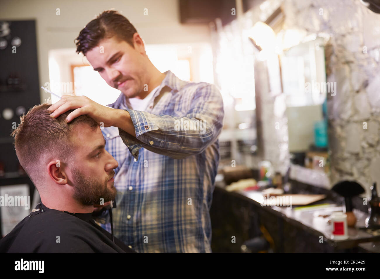 Male Barber Giving Client Haircut In Shop Stock Photo - Alamy