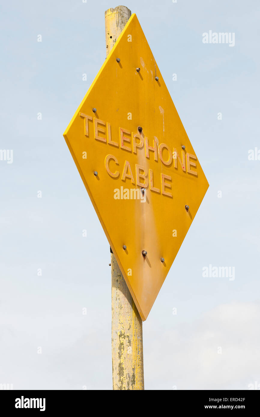yellow telephone cable sign Stock Photo - Alamy