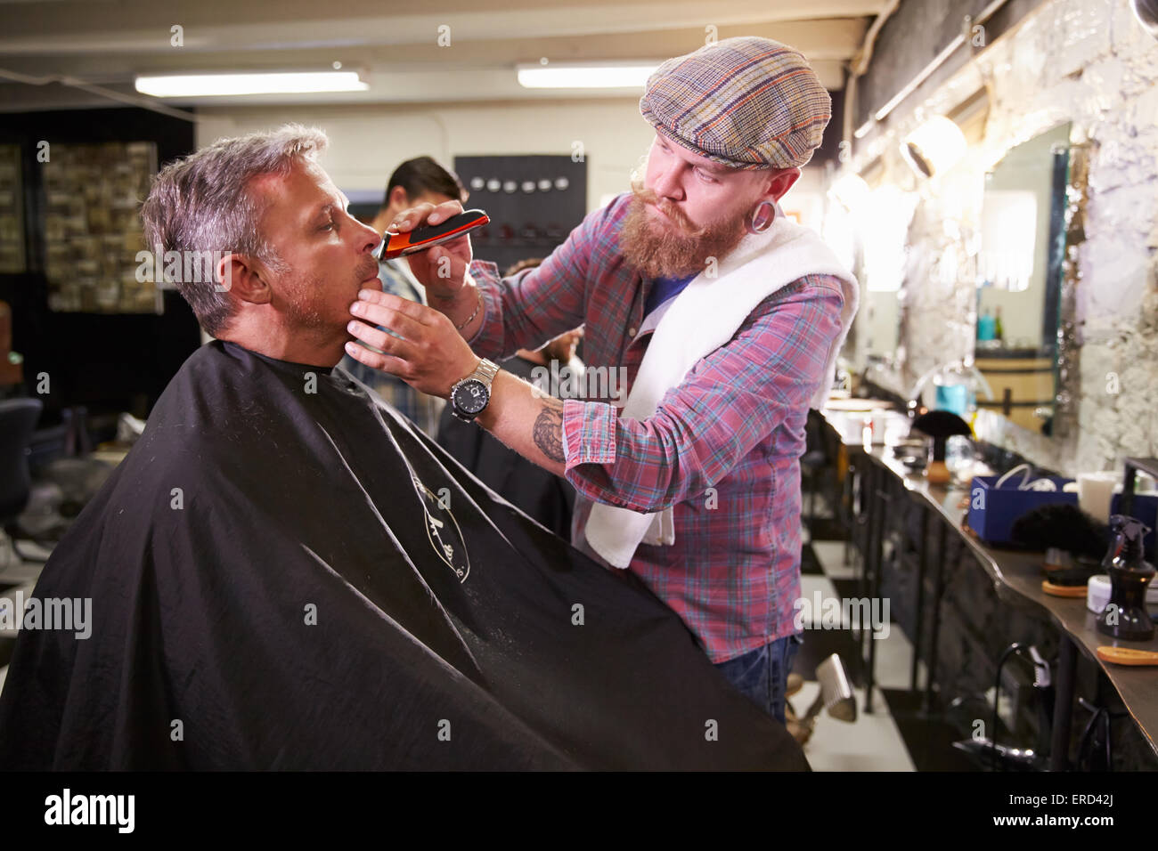Male Barber Giving Client Shave In Shop Stock Photo - Alamy
