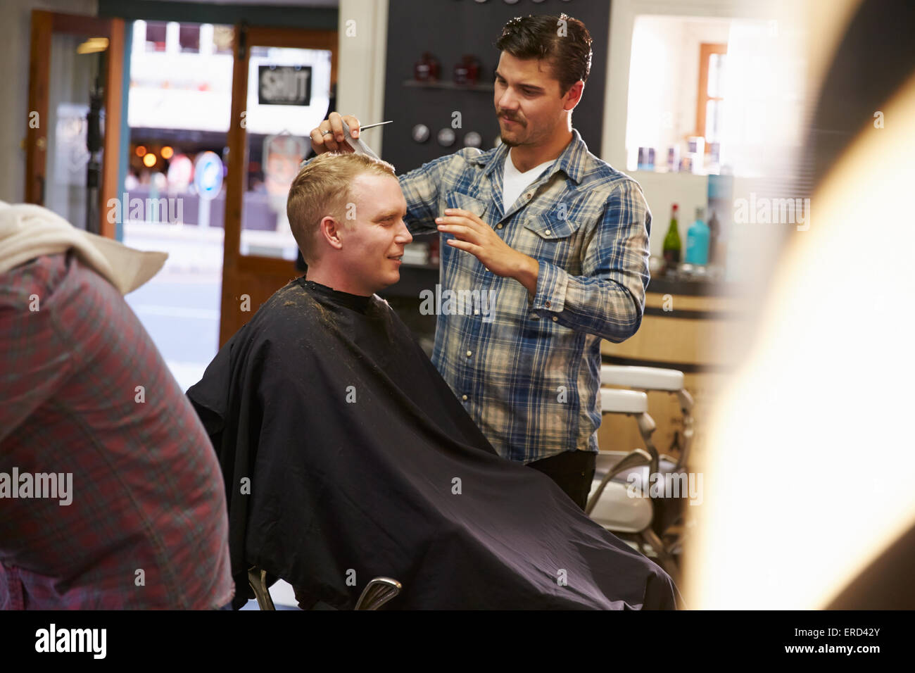 Male Barber Giving Client Haircut In Shop Stock Photo - Alamy