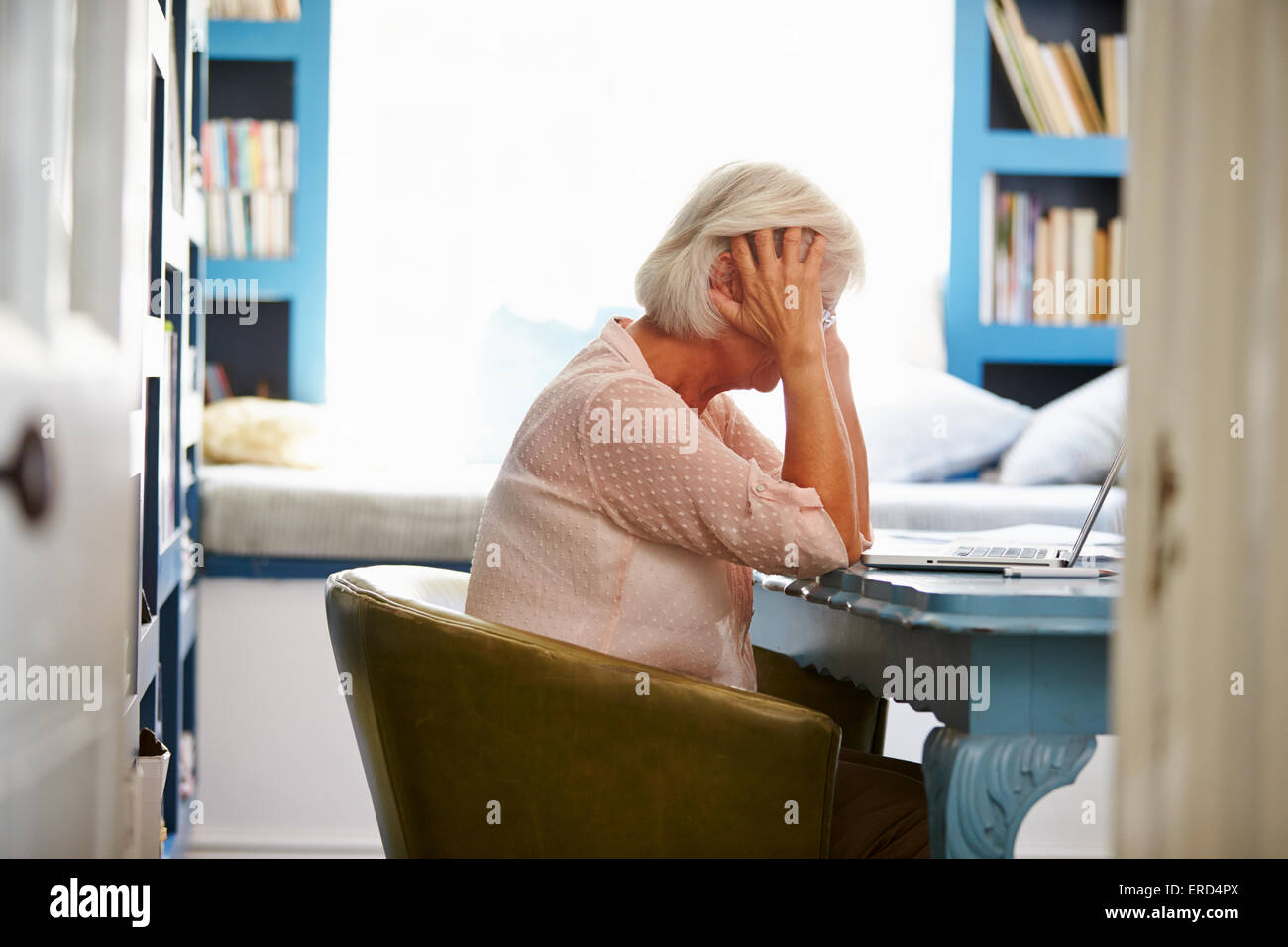 Stressed Senior Woman At Desk In Home Office With Laptop Stock Photo ...