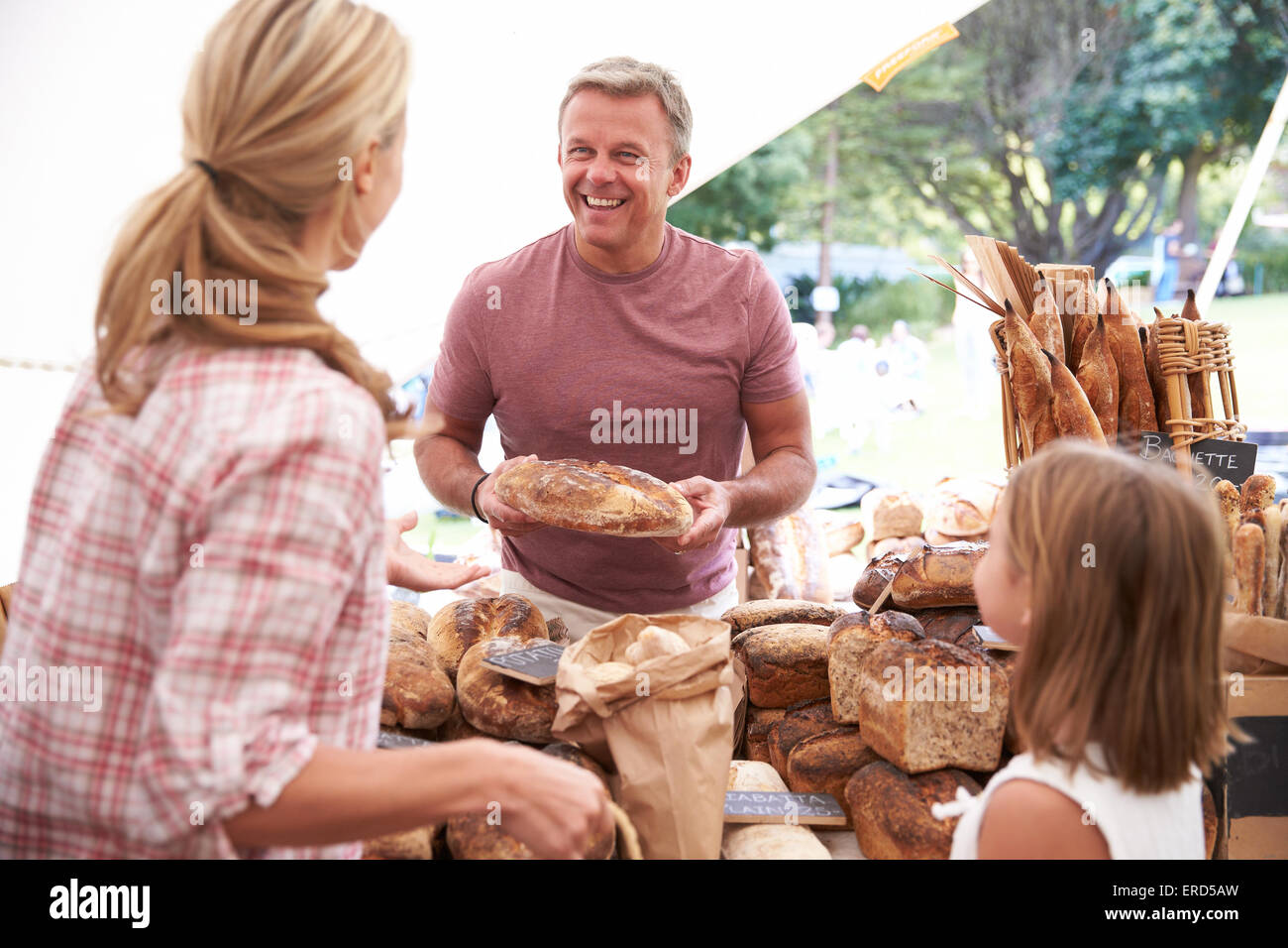 Family Buying Bread From Bakery Stall At Farmers Market Stock Photo - Alamy