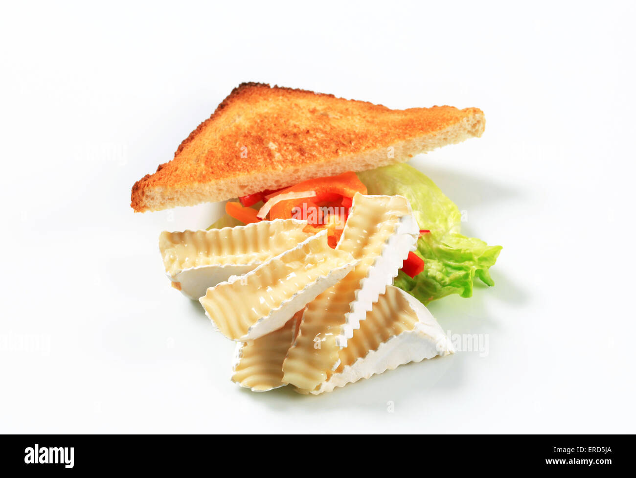 Toasted bread and wedges of white rind cheese Stock Photo - Alamy