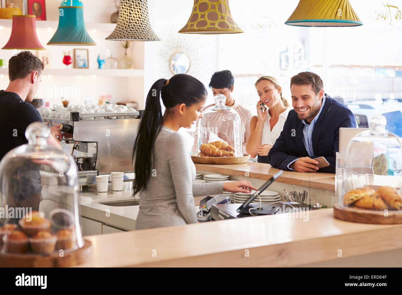 People ordering at the counter in a cafe Stock Photo - Alamy