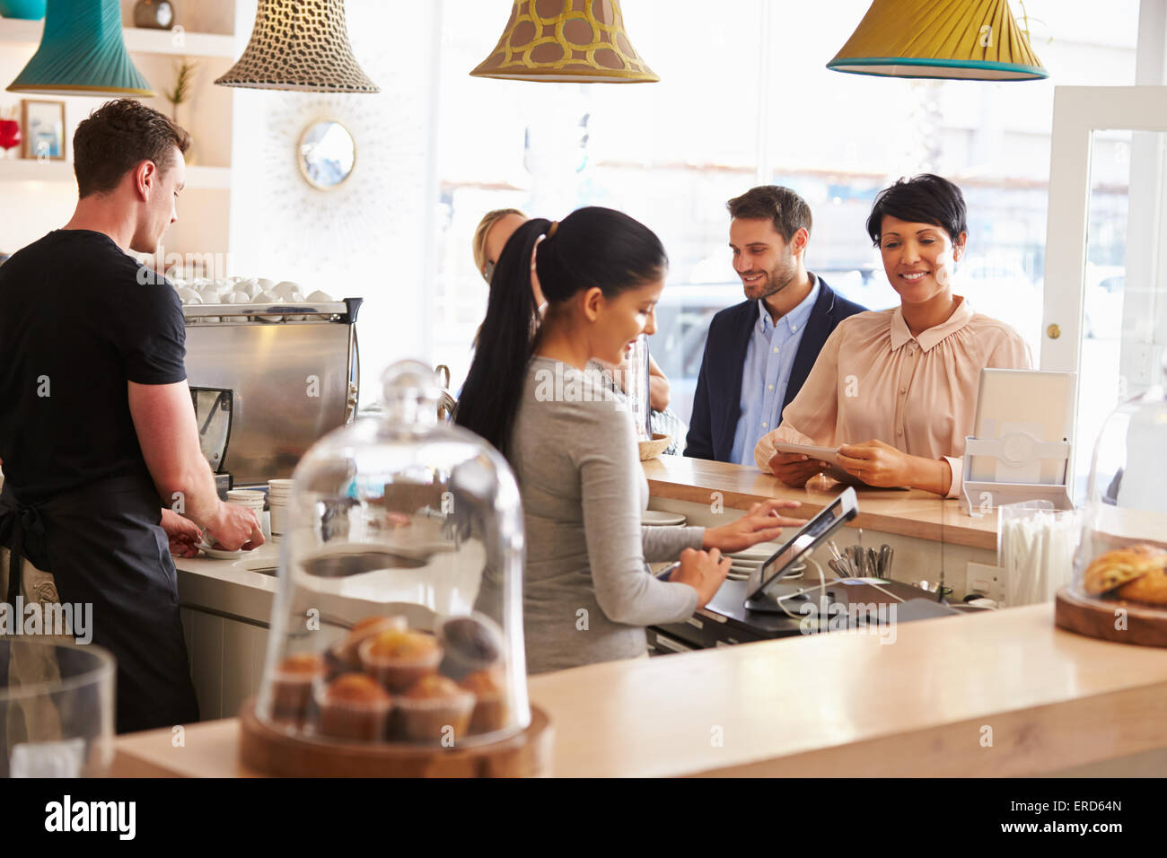 Cashier taking an order in cafe Stock Photo - Alamy
