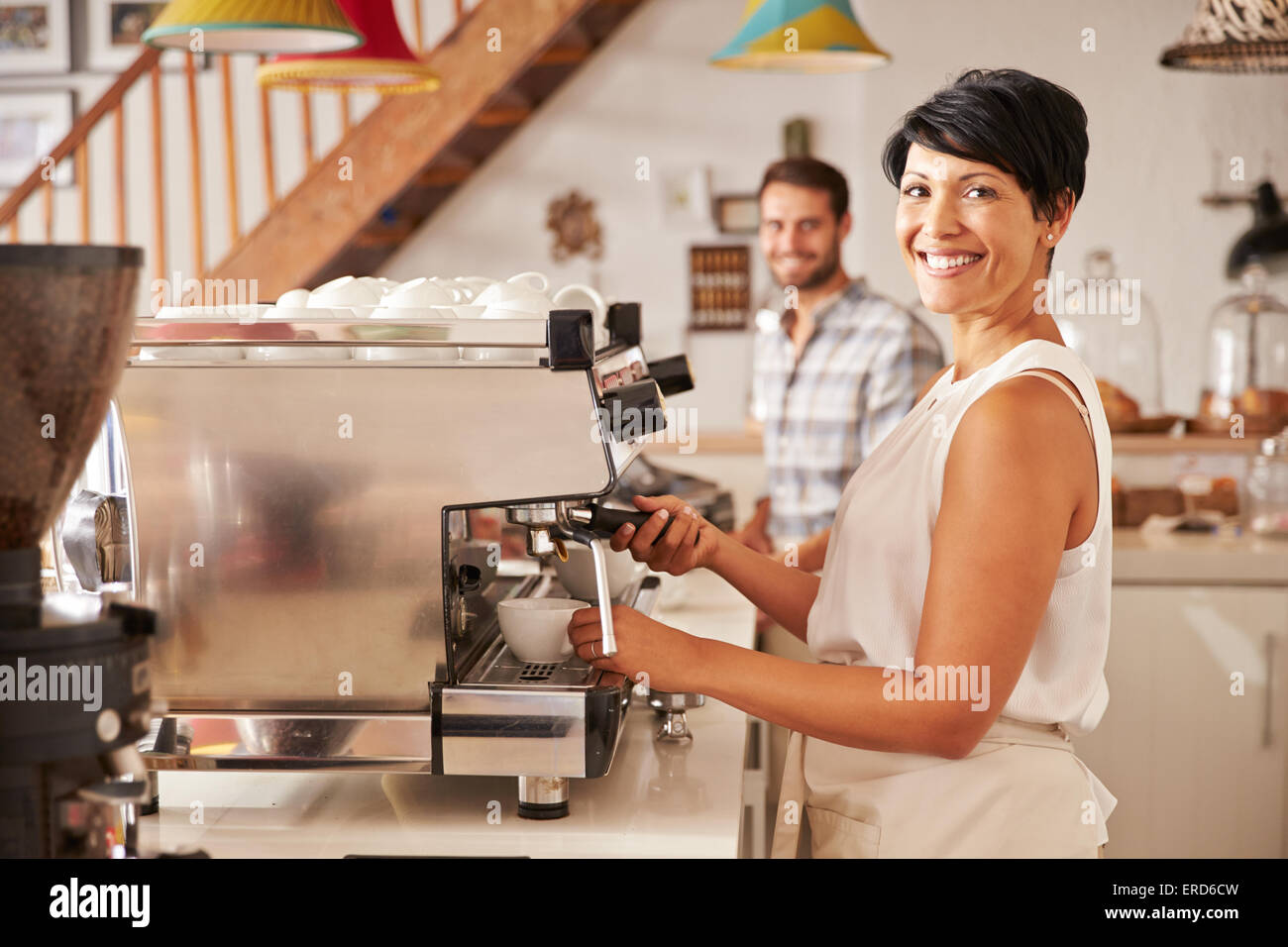 Owner helping in cafe Stock Photo - Alamy