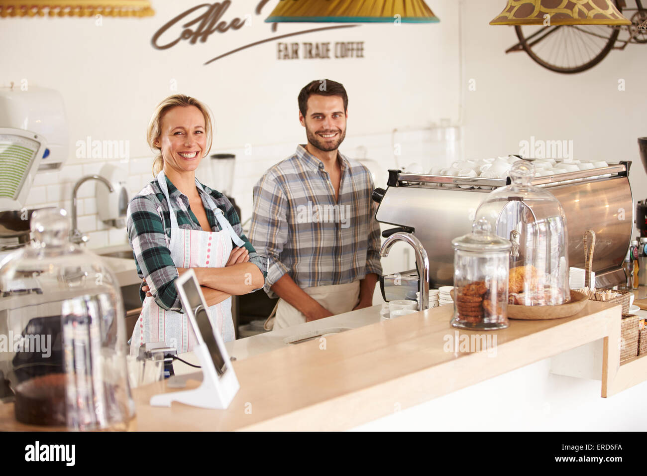 Smiling cafe workers in a coffee shop Stock Photo - Alamy