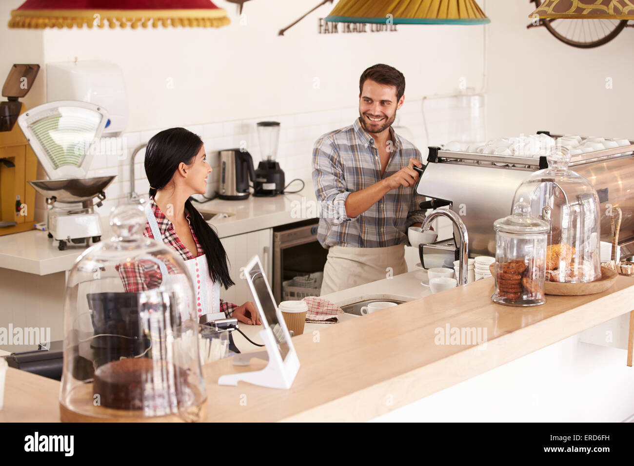 Happy young cafe workers Stock Photo - Alamy