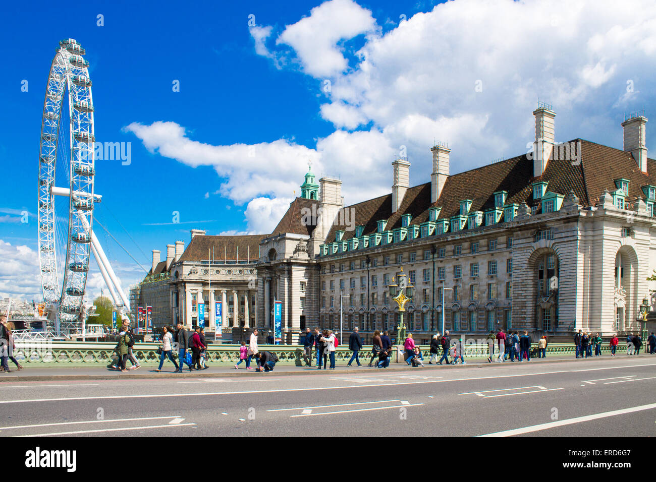 Millennium Eye and London County Hall. Sunny weather, tourists walking ...