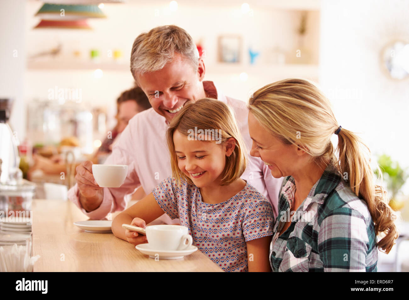 Happy family in a cafe Stock Photo - Alamy