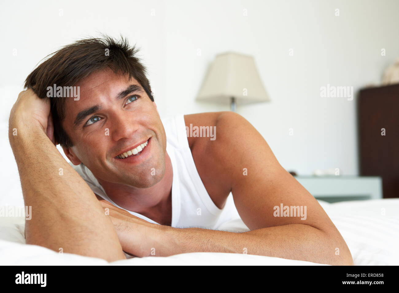 Portrait of Man Relaxing On Bed Stock Photo - Alamy