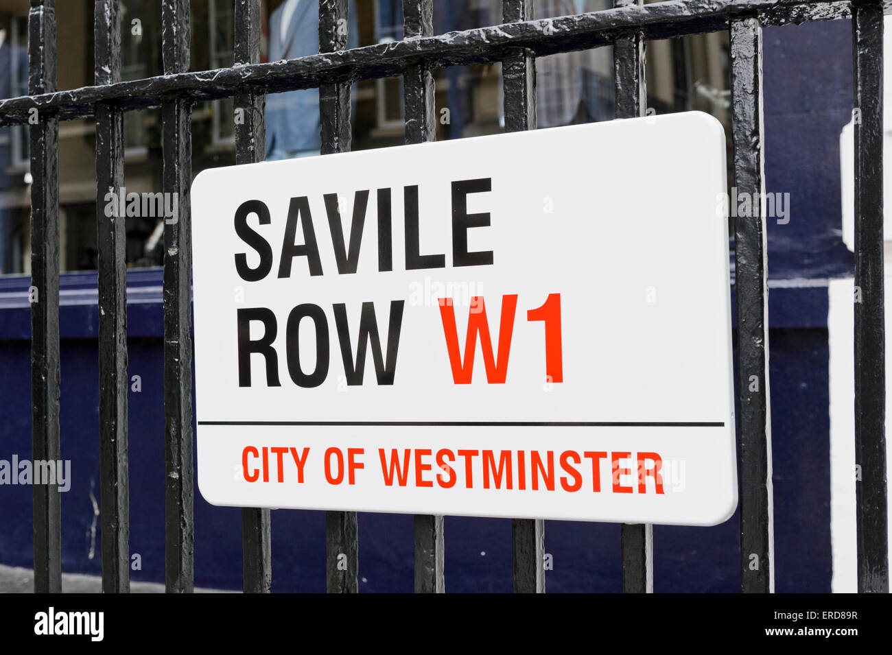 A road sign of the famous Savile Row fixed to steel railings, It is ...