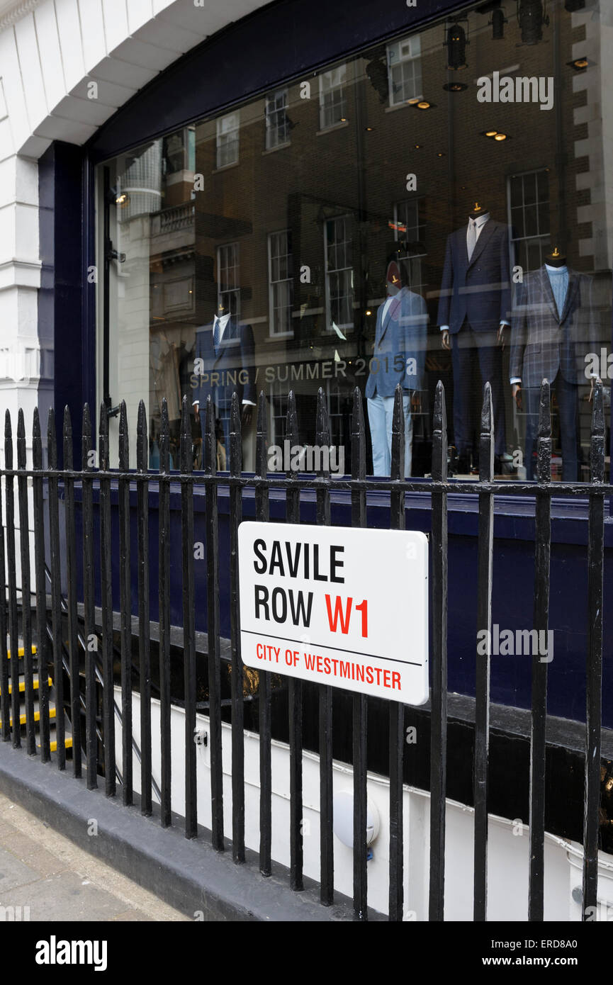 A road sign of the famous Savile Row fixed to steel railings, It is ...