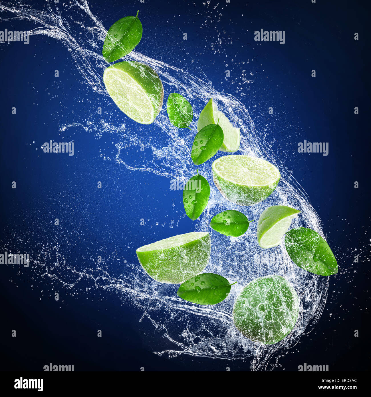 Ripe limes with water splash on dark background Stock Photo - Alamy