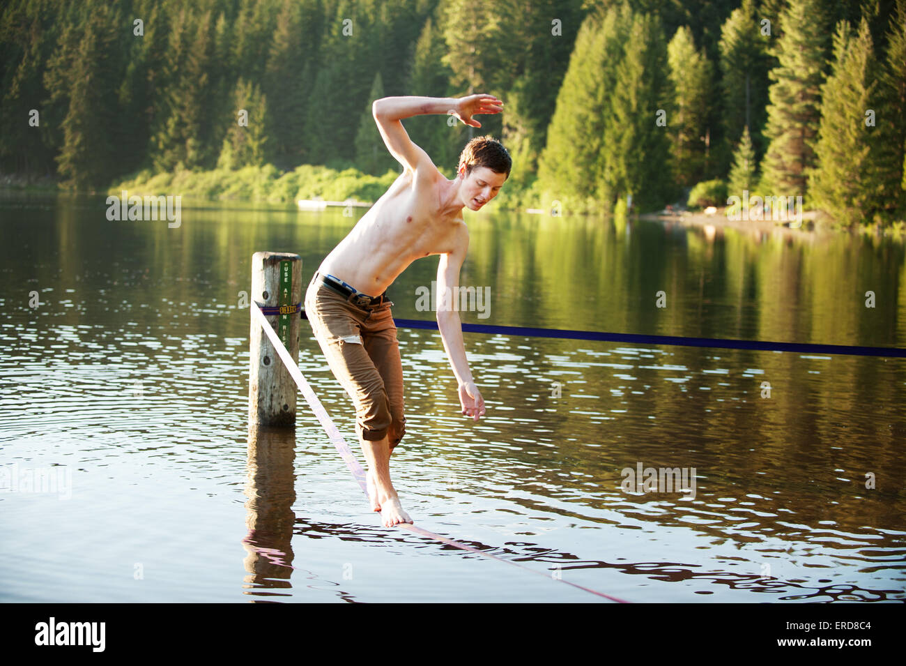 Josh Ayling walks a slack line at Lost Lake Park. Whistler BC, Canada ...