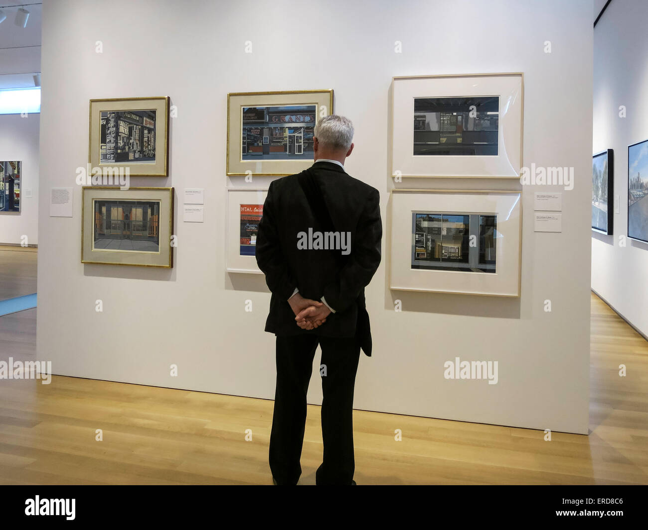 Mature man Enjoys Photo Exhibit at the Museum of Art and Design in ...