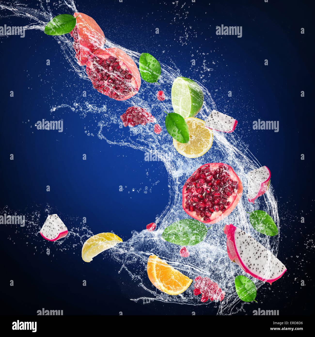 Fresh fruit with water splash on dark background Stock Photo - Alamy
