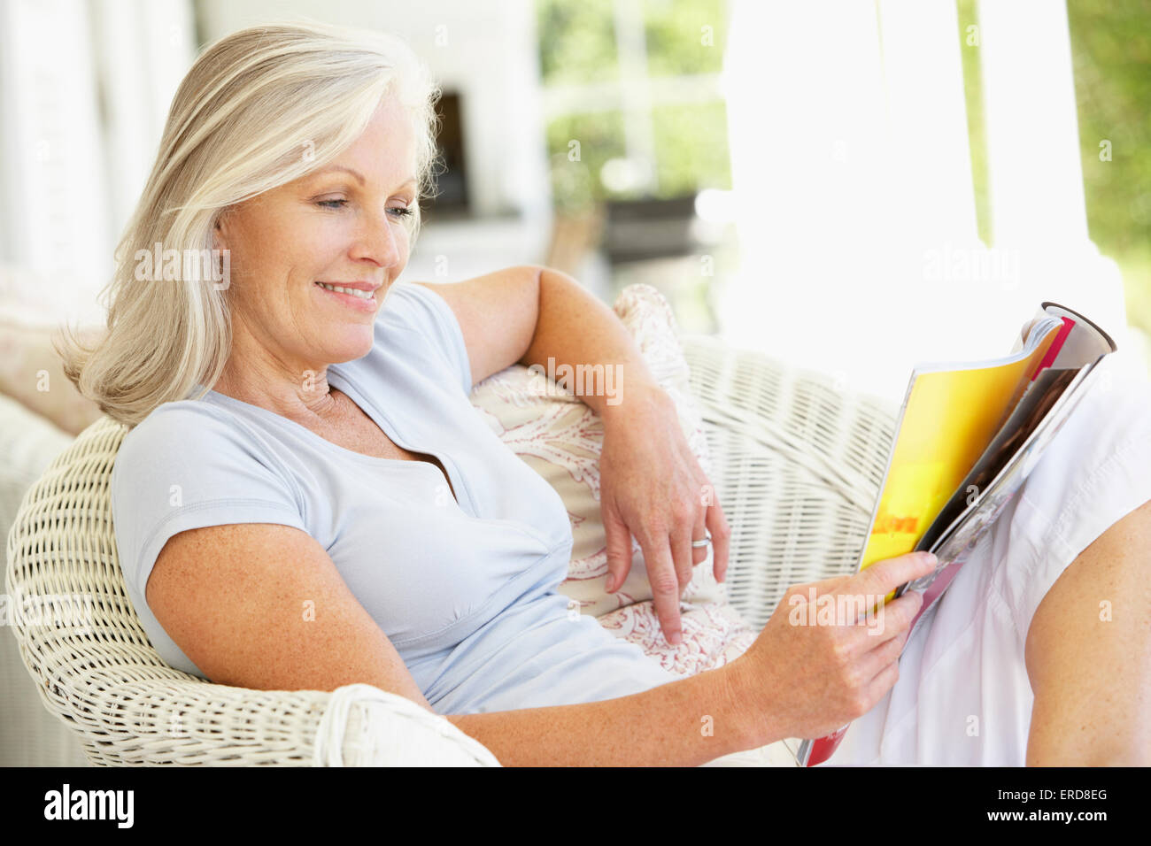 Senior woman reading outside Stock Photo - Alamy