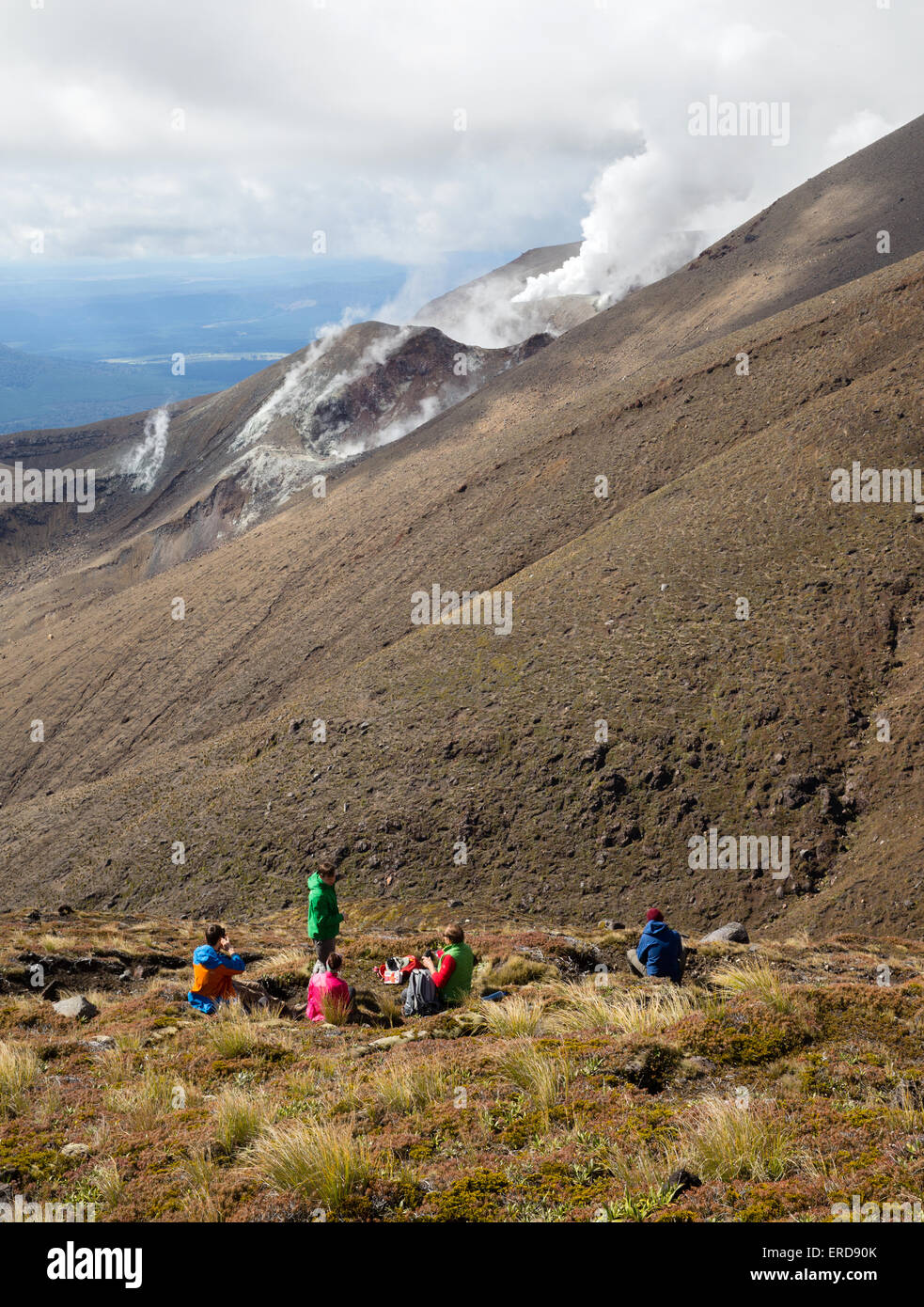 Walkers stop to watch steam rising from the active volcanic flanks of ...