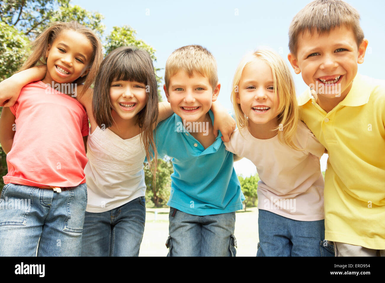 Group Of Smiling Children Relaxing In Park Stock Photo - Alamy