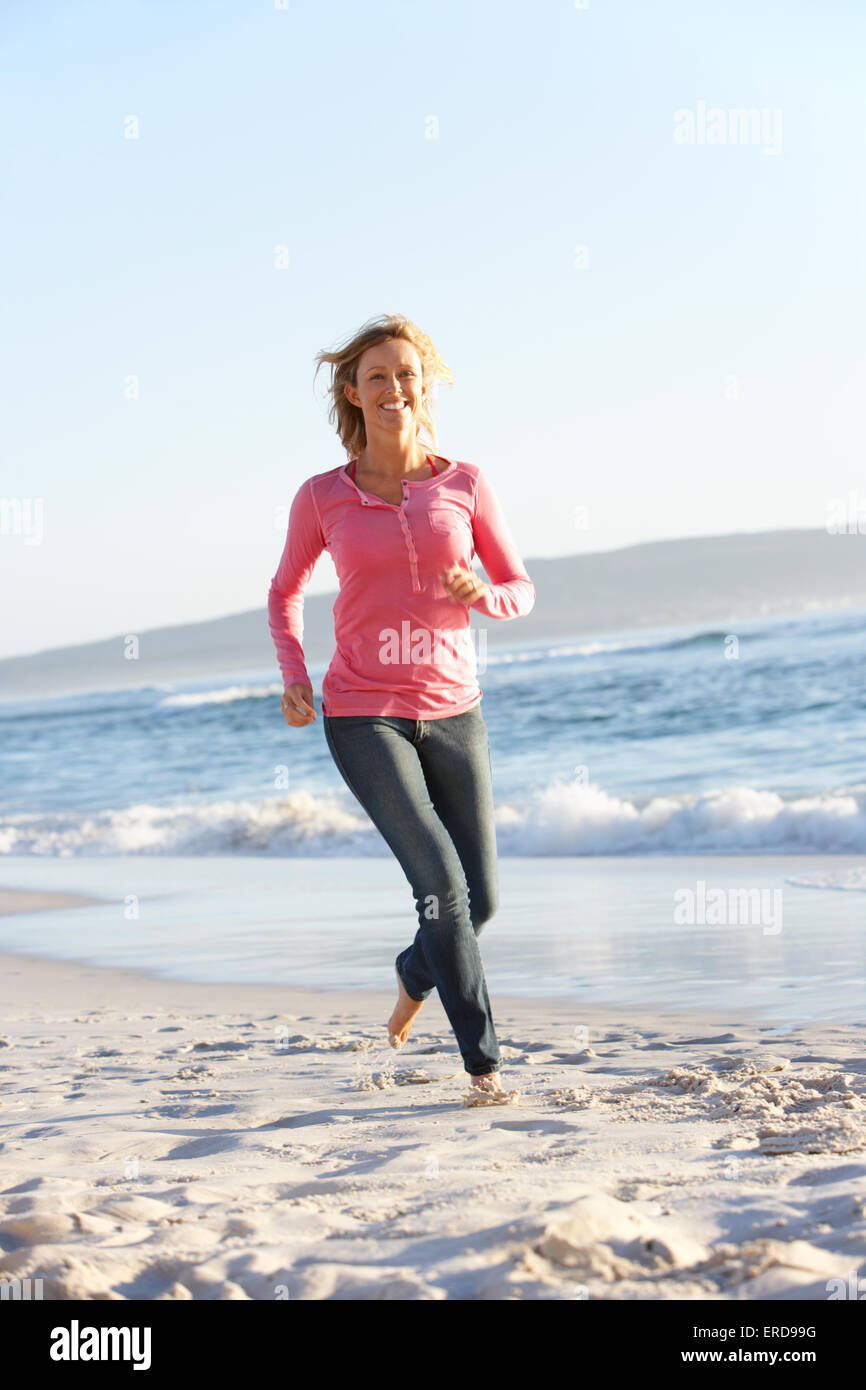 Woman jogging along sandy hi-res stock photography and images - Alamy