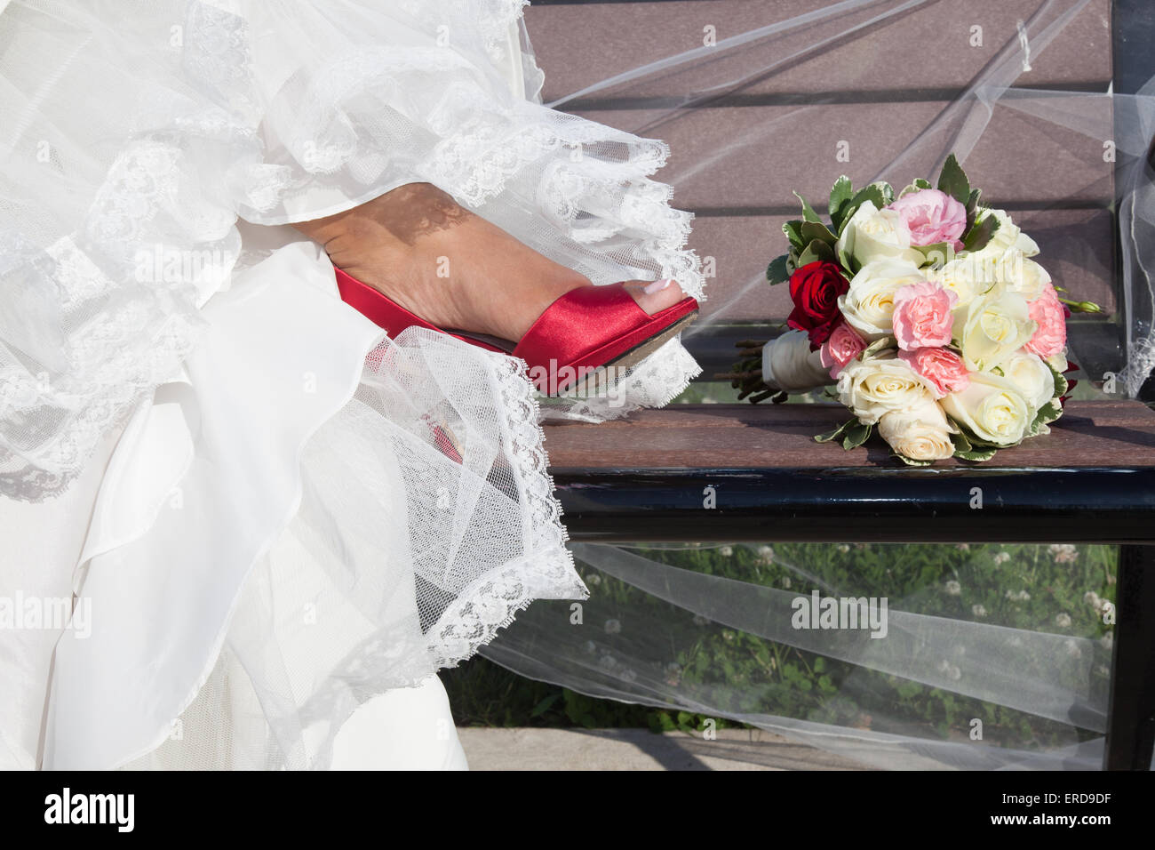 Bride foot and bouquet on bench Stock Photo - Alamy