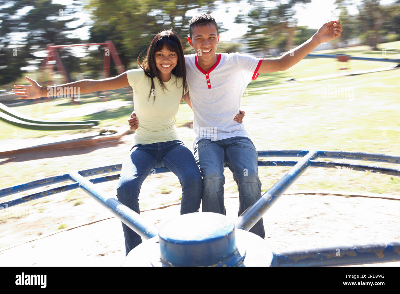 Teenage Couple Having Fun On Roundabout Stock Photo - Alamy