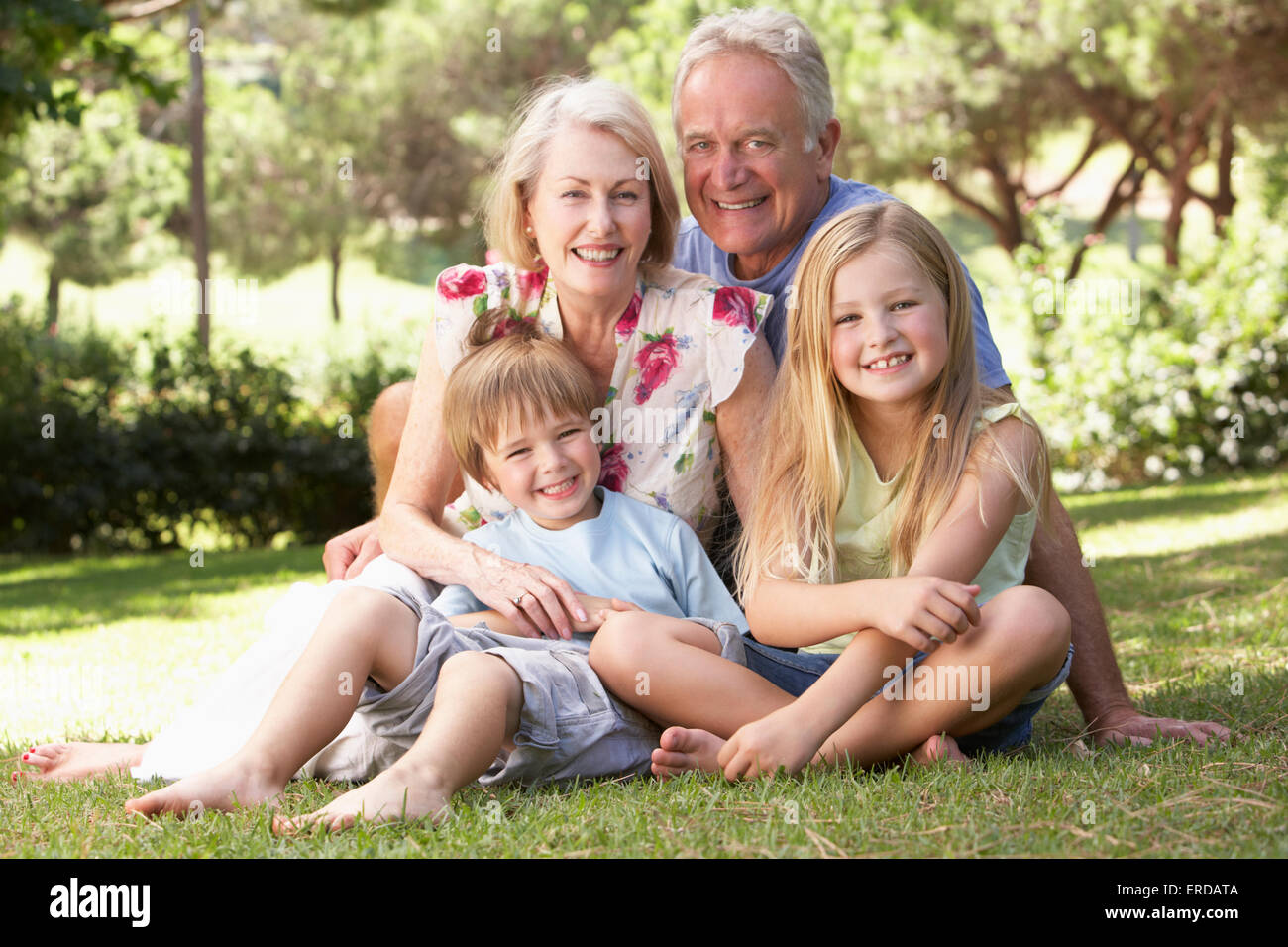 Grandparents And Grandchildren Sitting In Park Together Stock Photo - Alamy