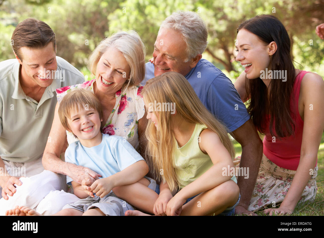 Three Generation Family Sitting In Park Together Stock Photo - Alamy