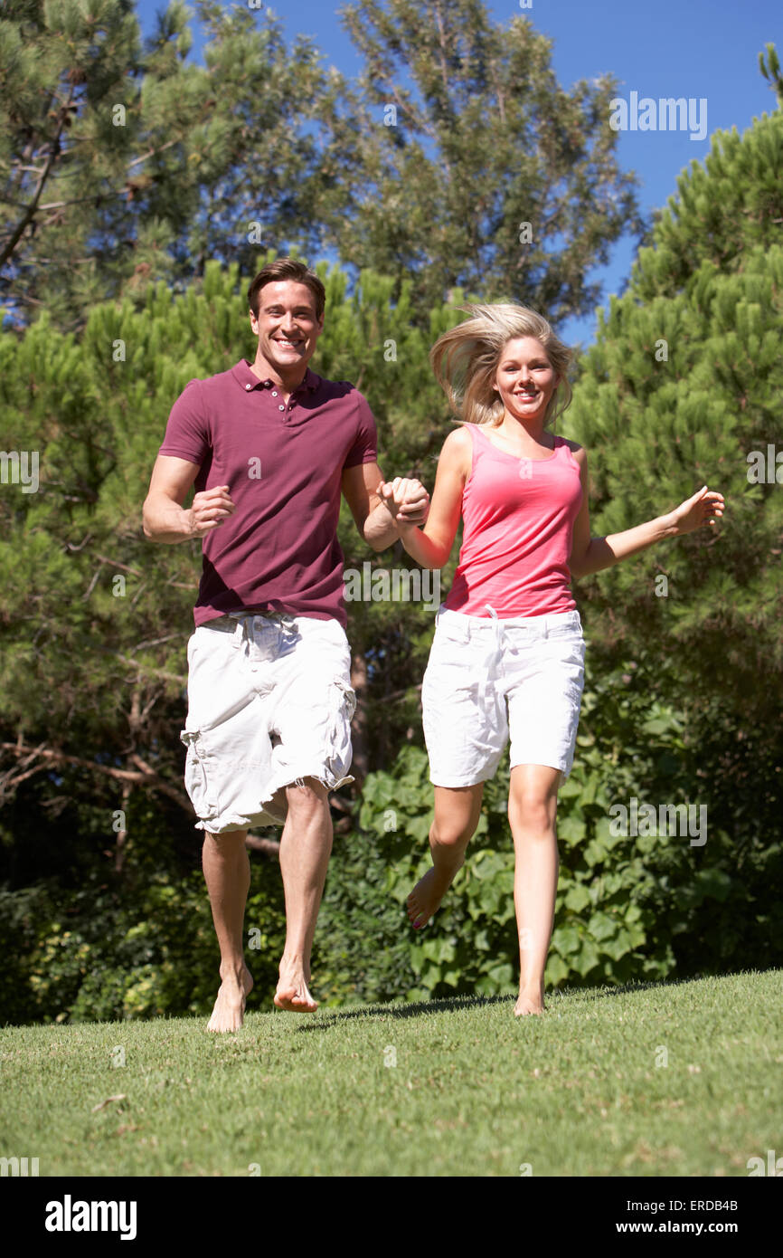 Young Couple Running Through Summer Field Stock Photo - Alamy