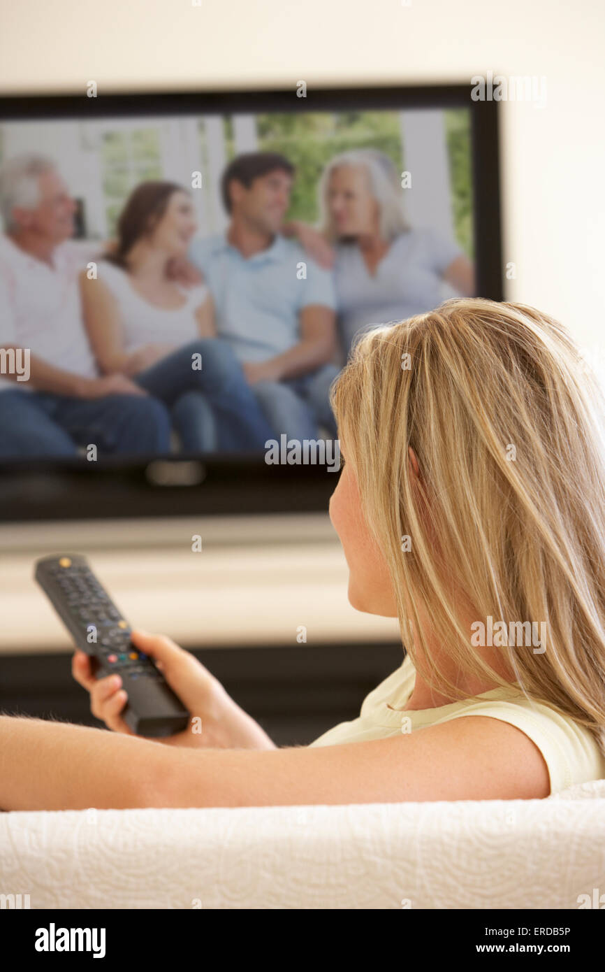 Woman Watching Widescreen TV At Home Stock Photo - Alamy