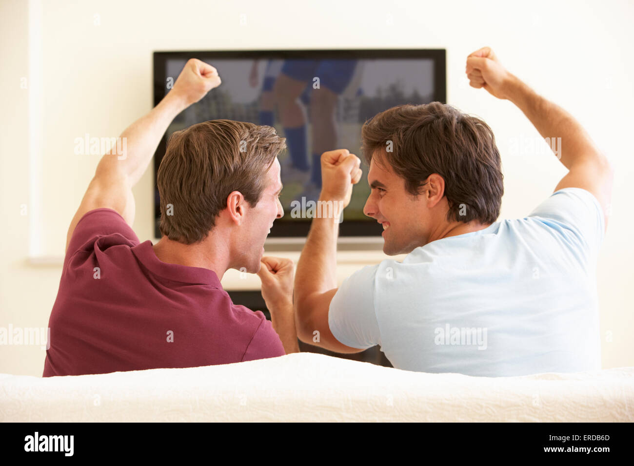 Two Men Watching Widescreen TV At Home Stock Photo - Alamy