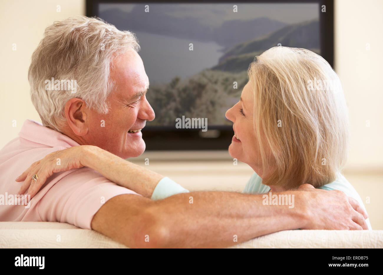 Senior Couple Watching Widescreen TV At Home Stock Photo - Alamy