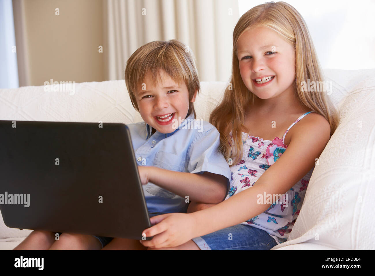 Two Young Children Using Laptop At Home Stock Photo - Alamy