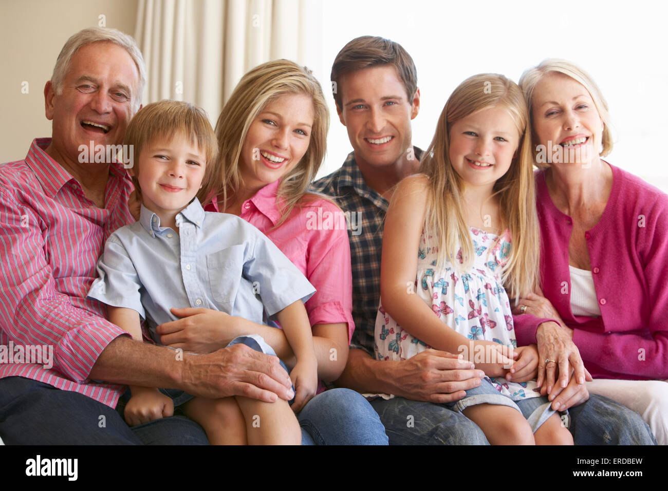 Three Generation Family Relaxing On Sofa At Home Stock Photo - Alamy