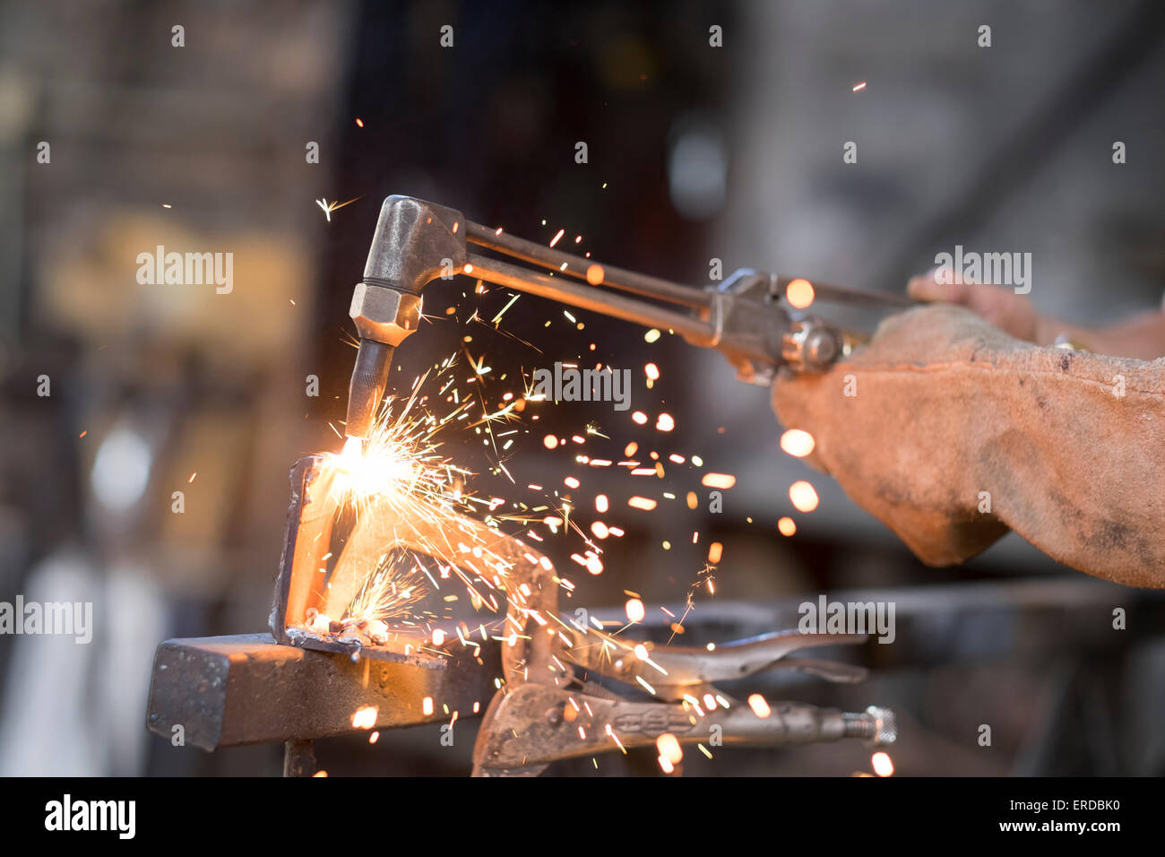 Close up photograph of welding torch causing sparks of burning metal in ...