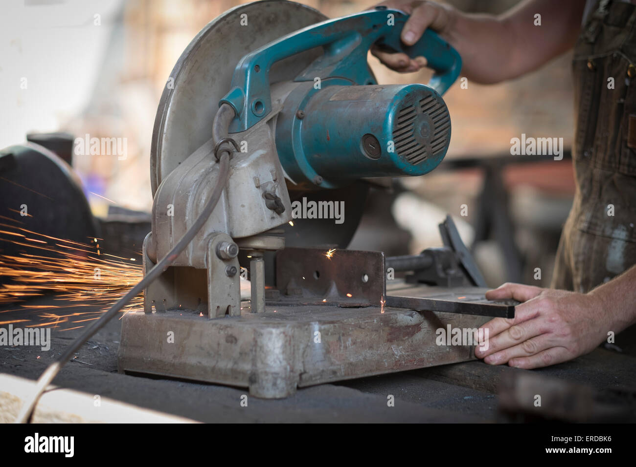 Close up of table disc grinder being used for cutting metal. Sparks ...