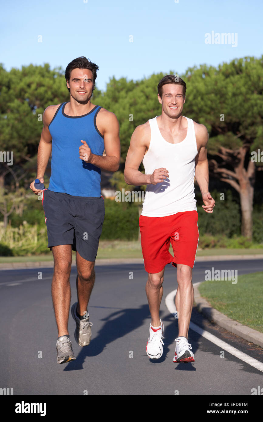 Two Men Running On Road Stock Photo - Alamy