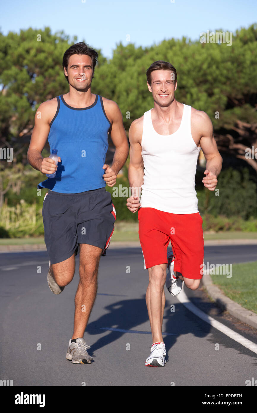 Two Men Running On Road Stock Photo - Alamy