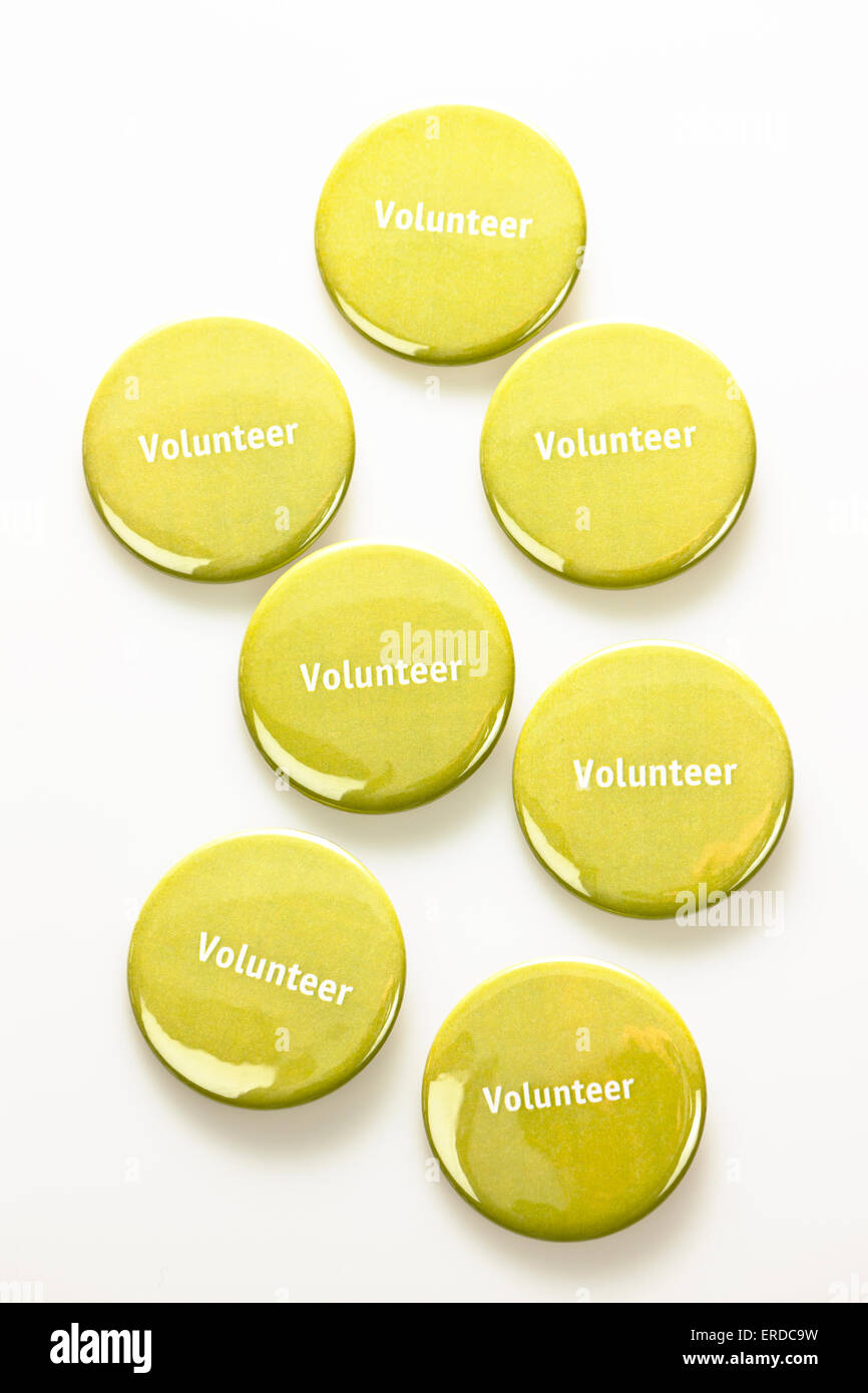 Several green volunteer buttons on white background Stock Photo - Alamy