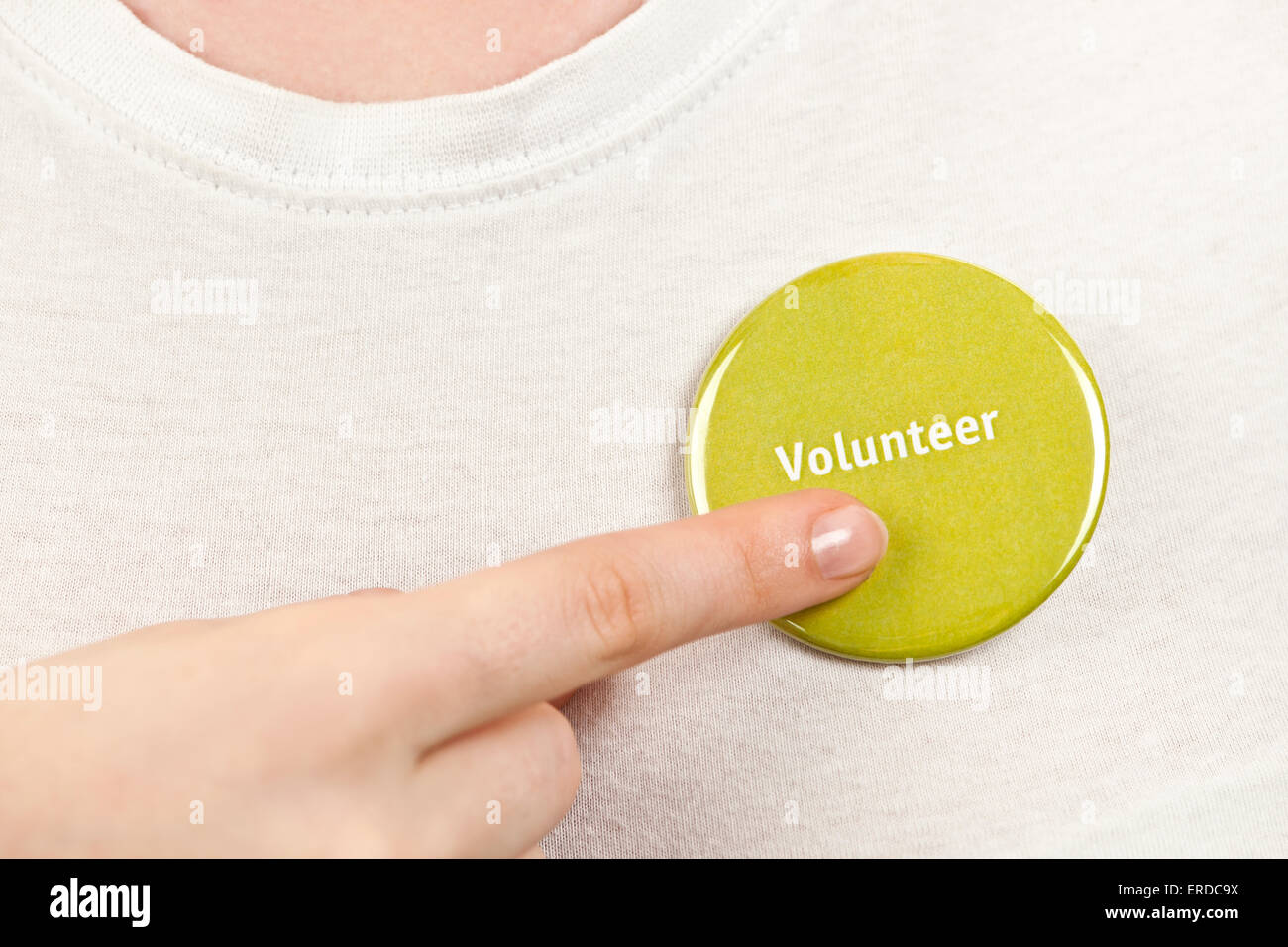 Closeup on female hand pointing to green volunteer button Stock Photo ...