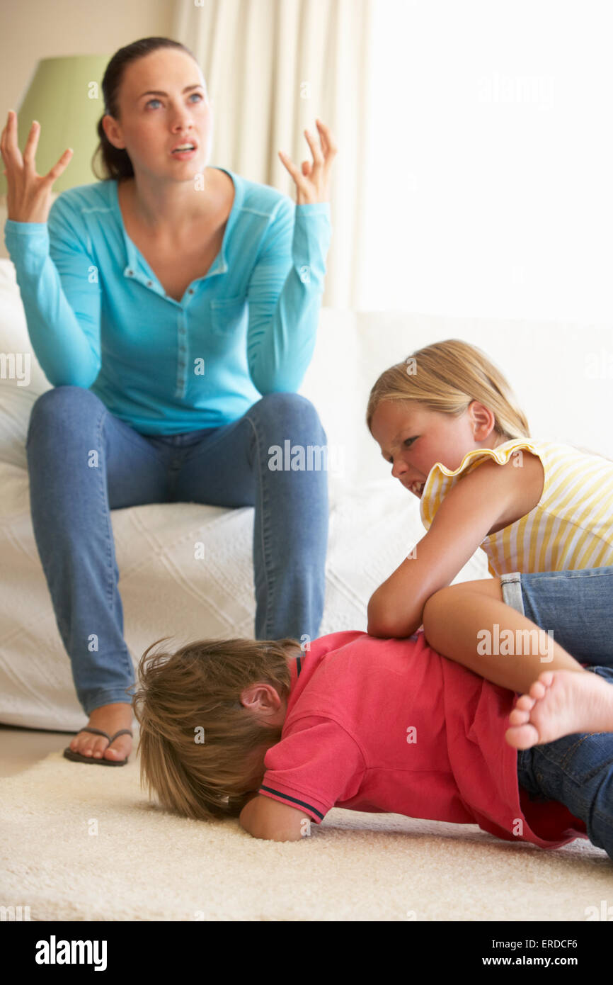 Children Fighting In Front Of Mother At Home Stock Photo - Alamy