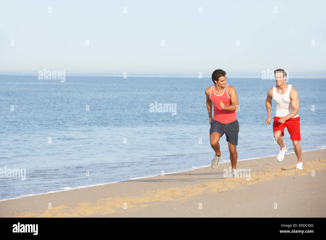 Two Young Men Jogging Along Beach Stock Photo - Alamy Two Young Men Jogging Along Beach Stock Photo - Alamy