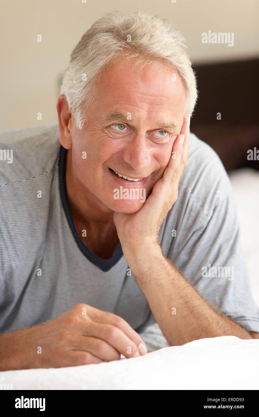 Senior Man Relaxing On Bed Stock Photo - Alamy