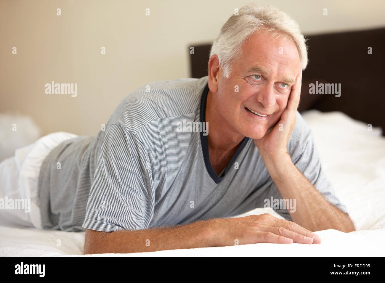 Senior Man Relaxing On Bed Stock Photo - Alamy