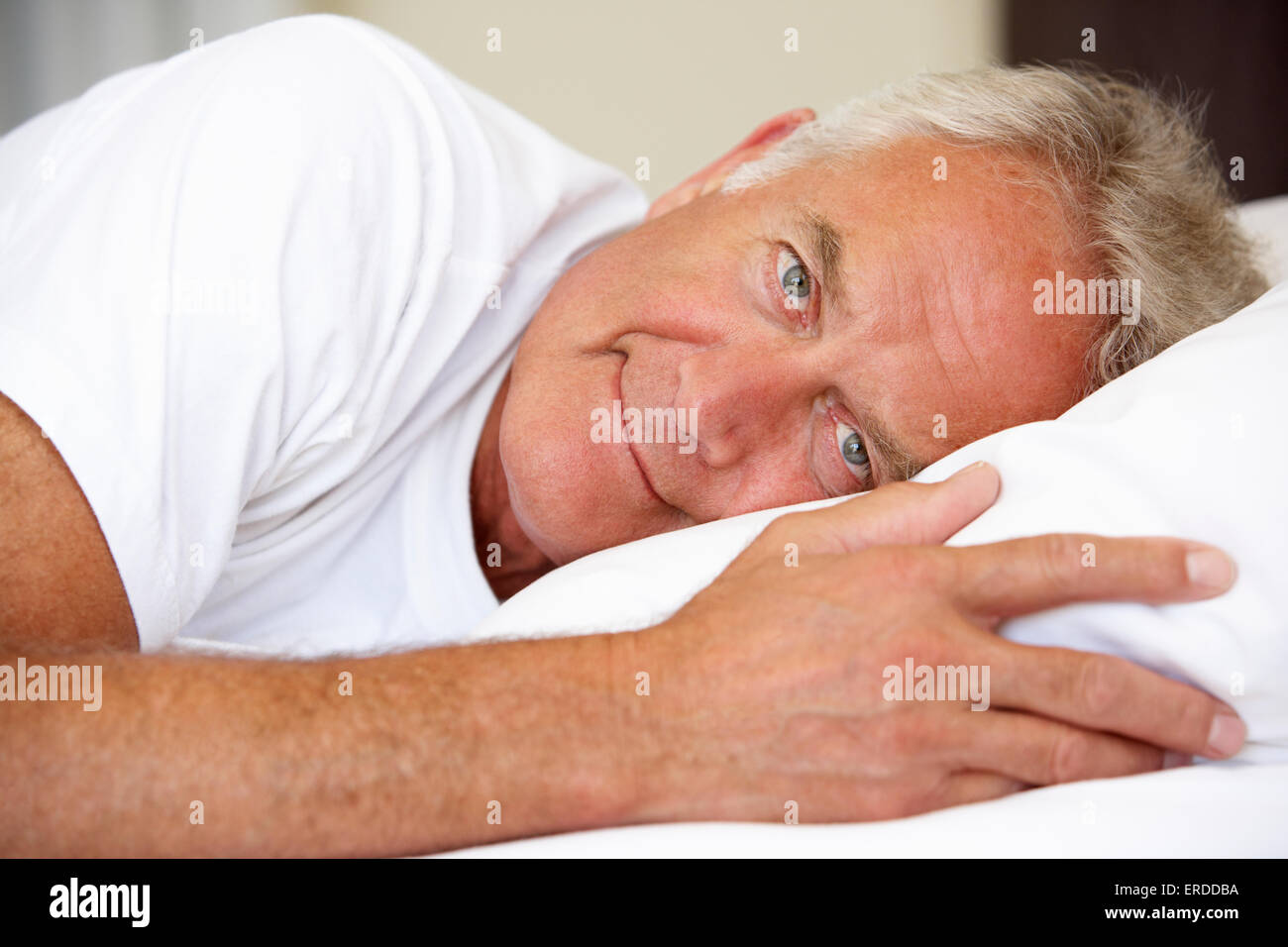 Senior Man Relaxing On Bed Stock Photo - Alamy