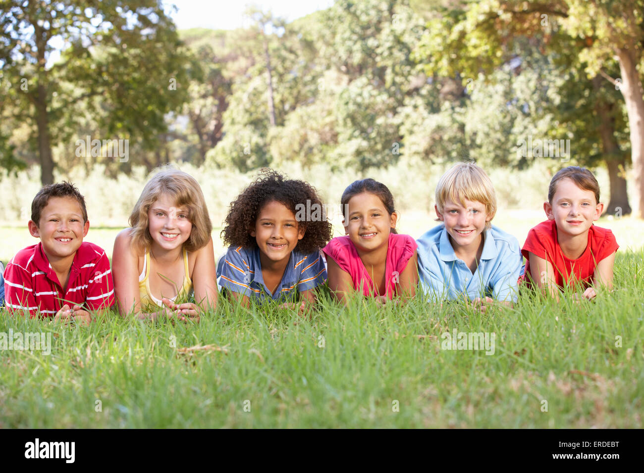Group Of Children Relaxing In Countryside Stock Photo - Alamy