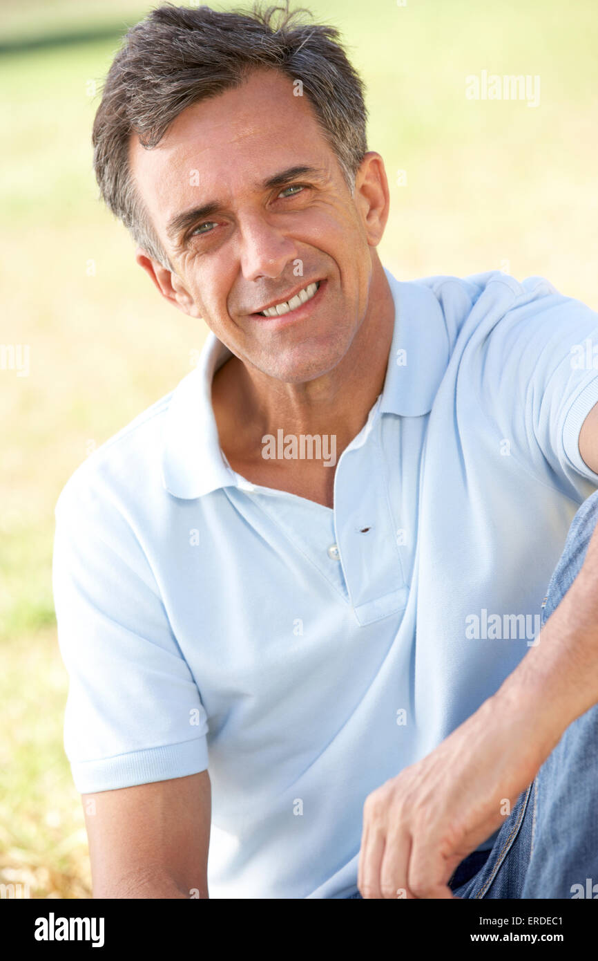 Middle Aged Man Relaxing In Countryside Stock Photo - Alamy