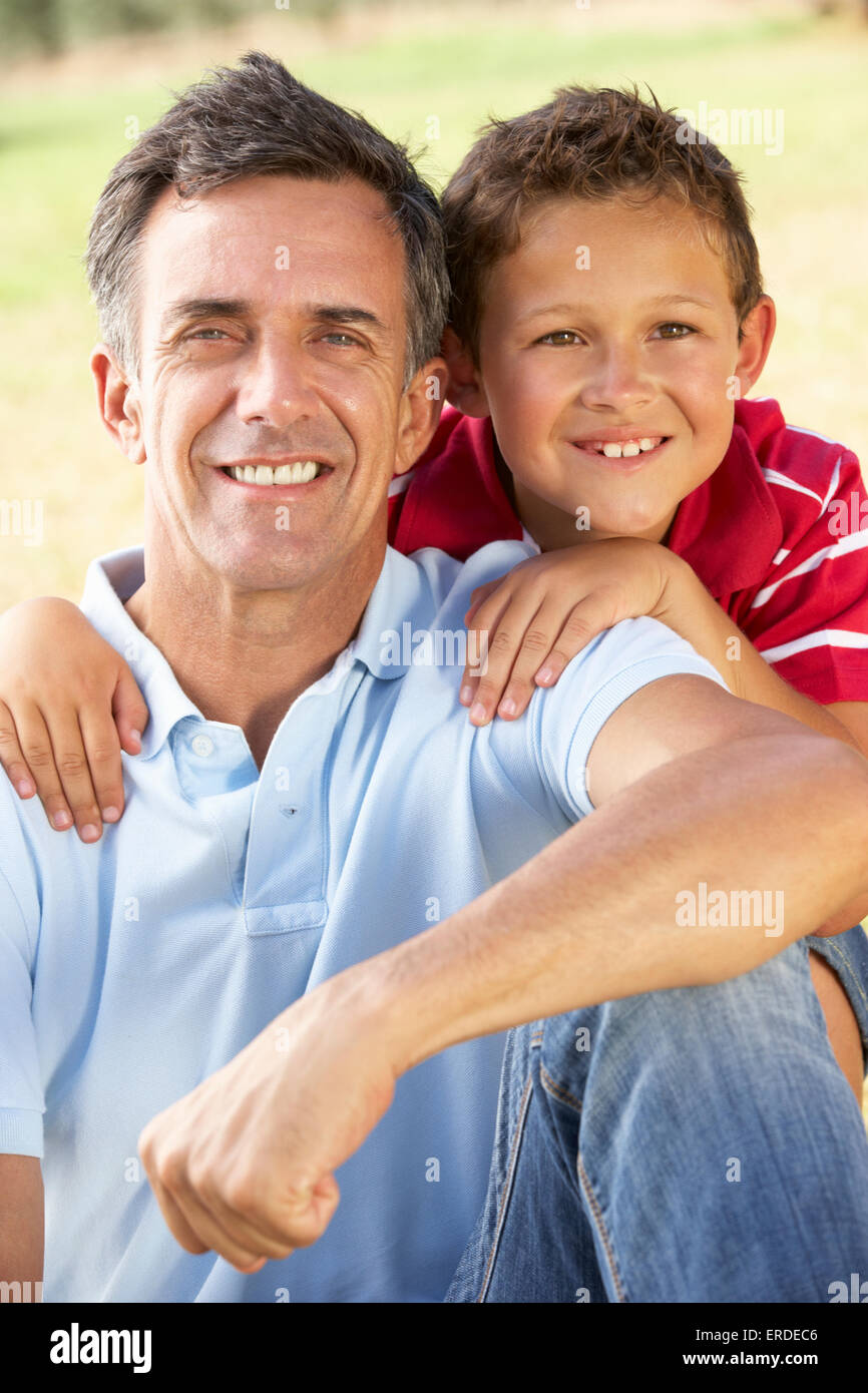 Middle Aged Father And Son Relaxing In Countryside Stock Photo - Alamy