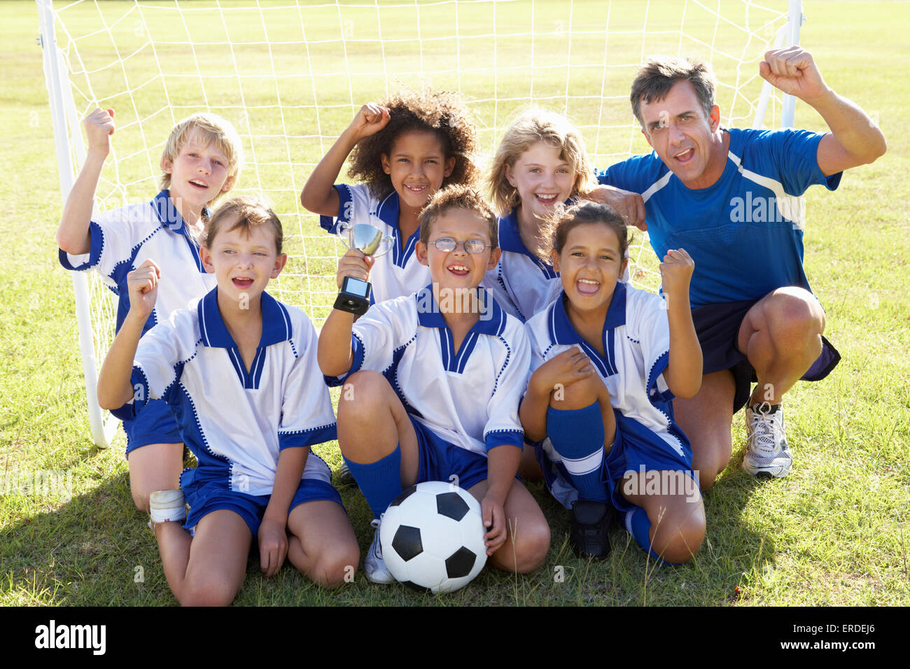 Group Of Children In Soccer Team Celebrating With Trophy Stock Photo - Alamy